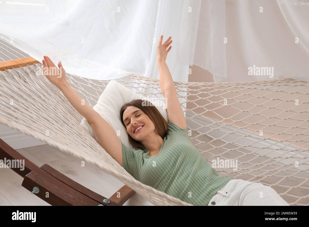 Happy woman lying in hammock at home Stock Photo - Alamy