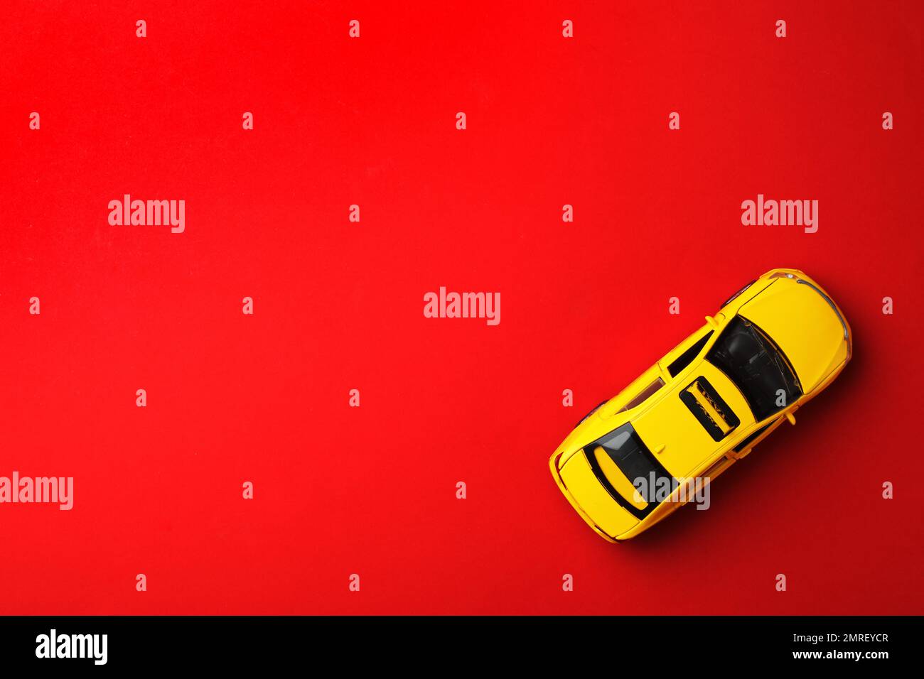 Yellow taxi car model on red background, top view. Space for text Stock ...