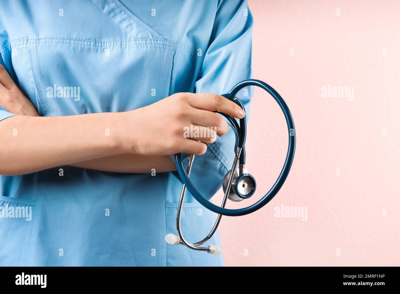 Doctor with stethoscope on pink background, closeup. Medical service Stock Photo - Alamy