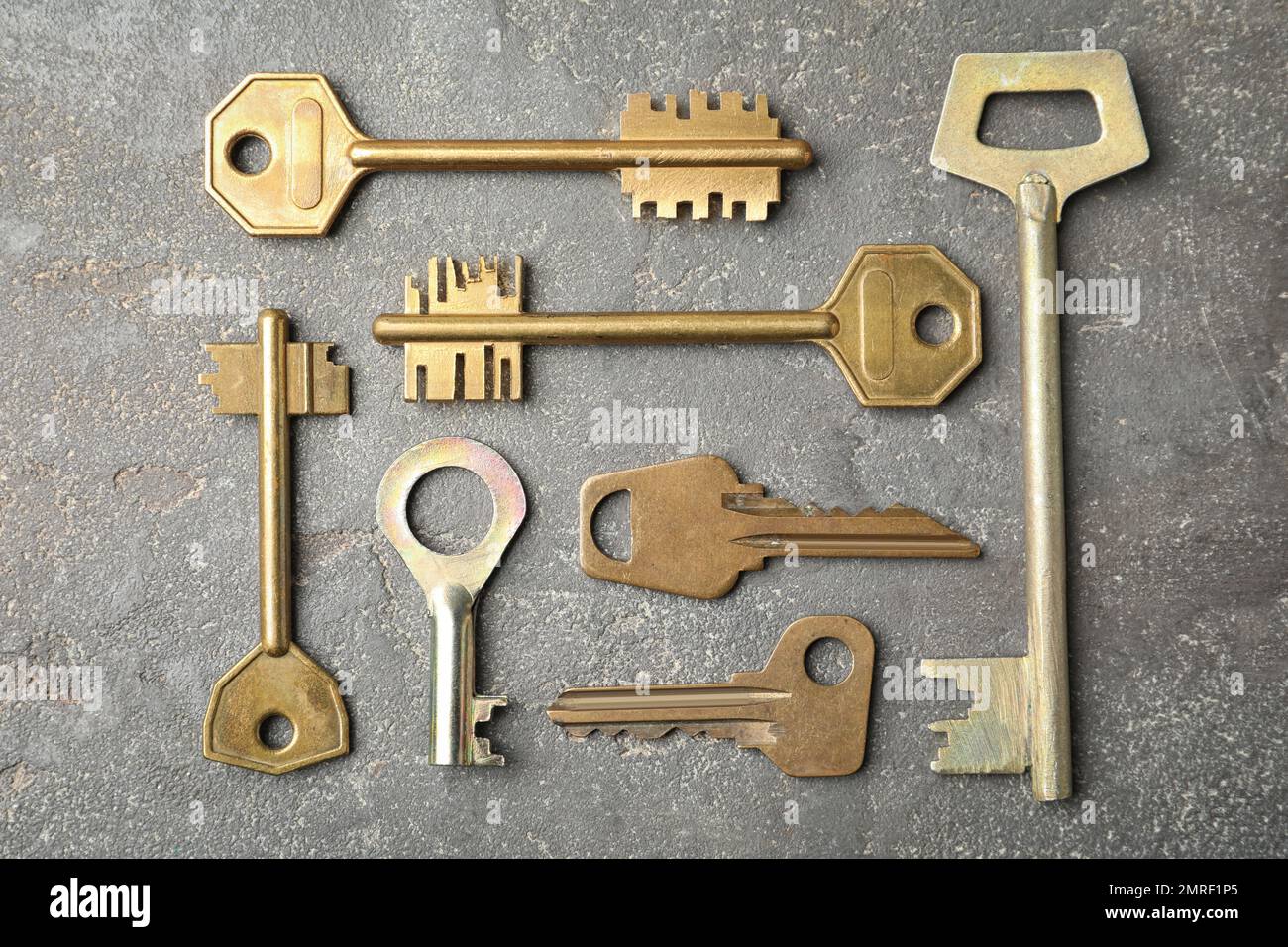 Steel keys on grey background, flat lay. Safety concept Stock Photo - Alamy