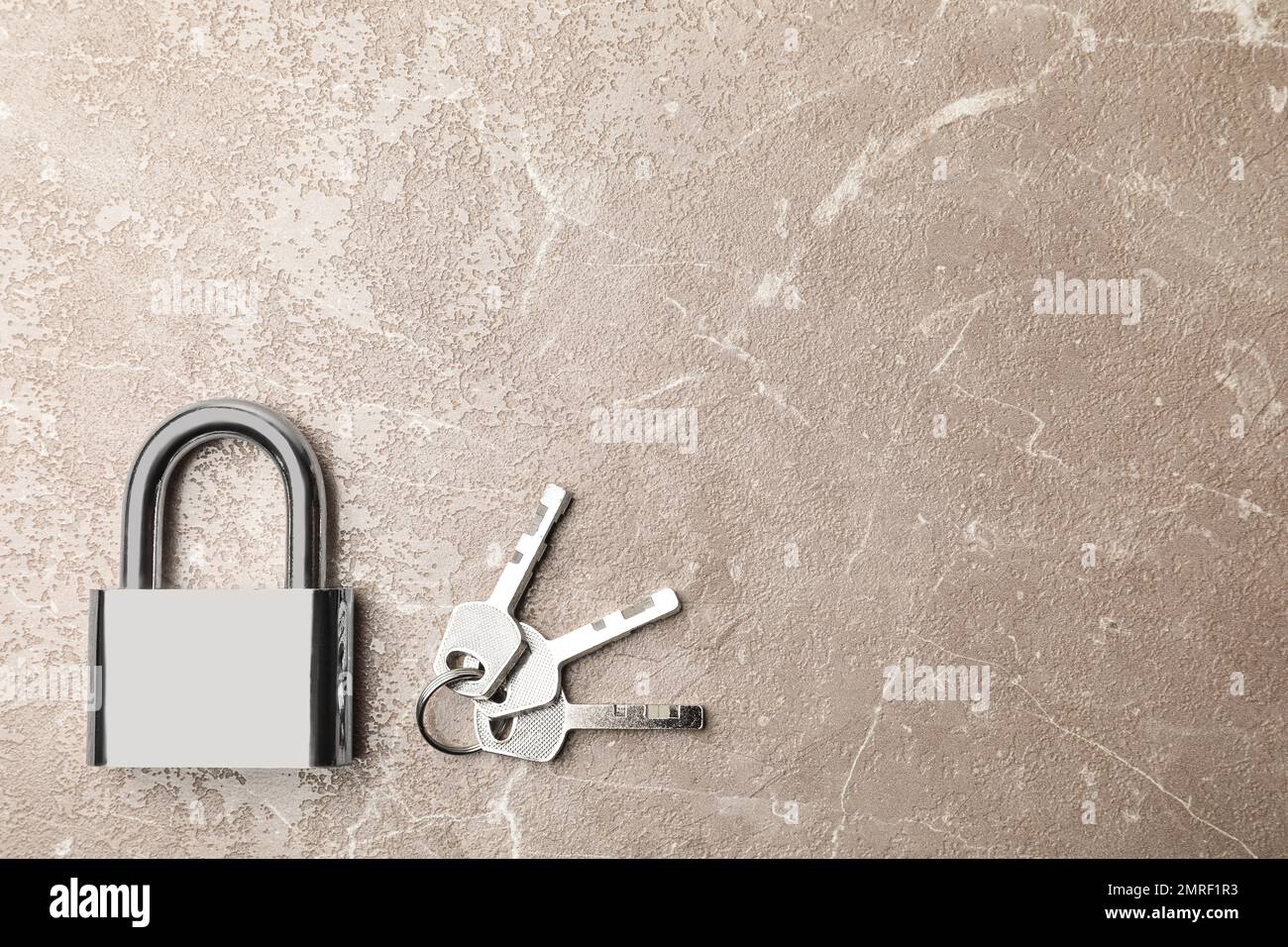 Steel padlock, keys and space for text on marble background, flat lay ...