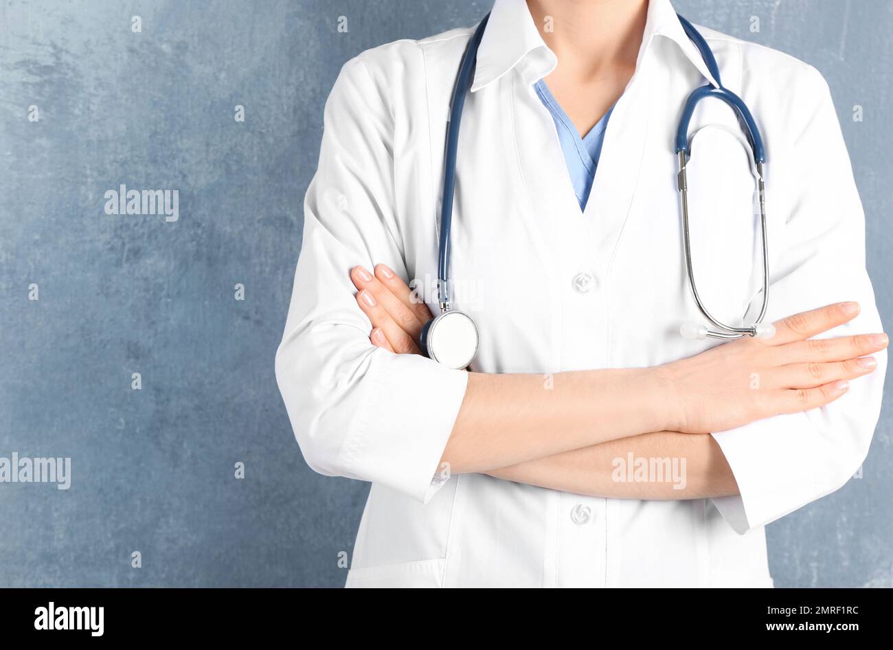 Doctor with stethoscope on blue background, closeup. Medical service Stock Photo - Alamy