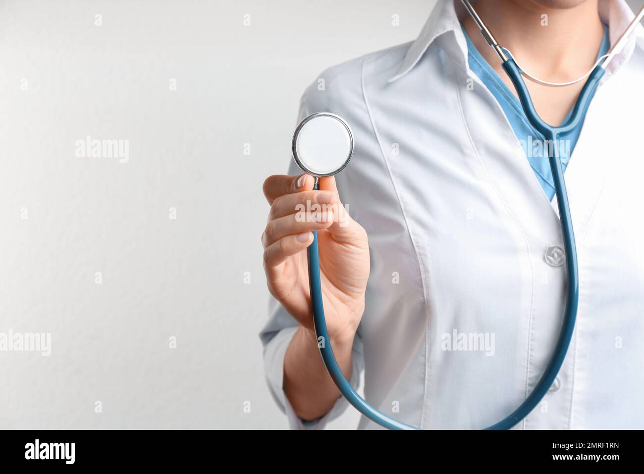 Doctor with stethoscope on white background, closeup. Medical service Stock Photo - Alamy