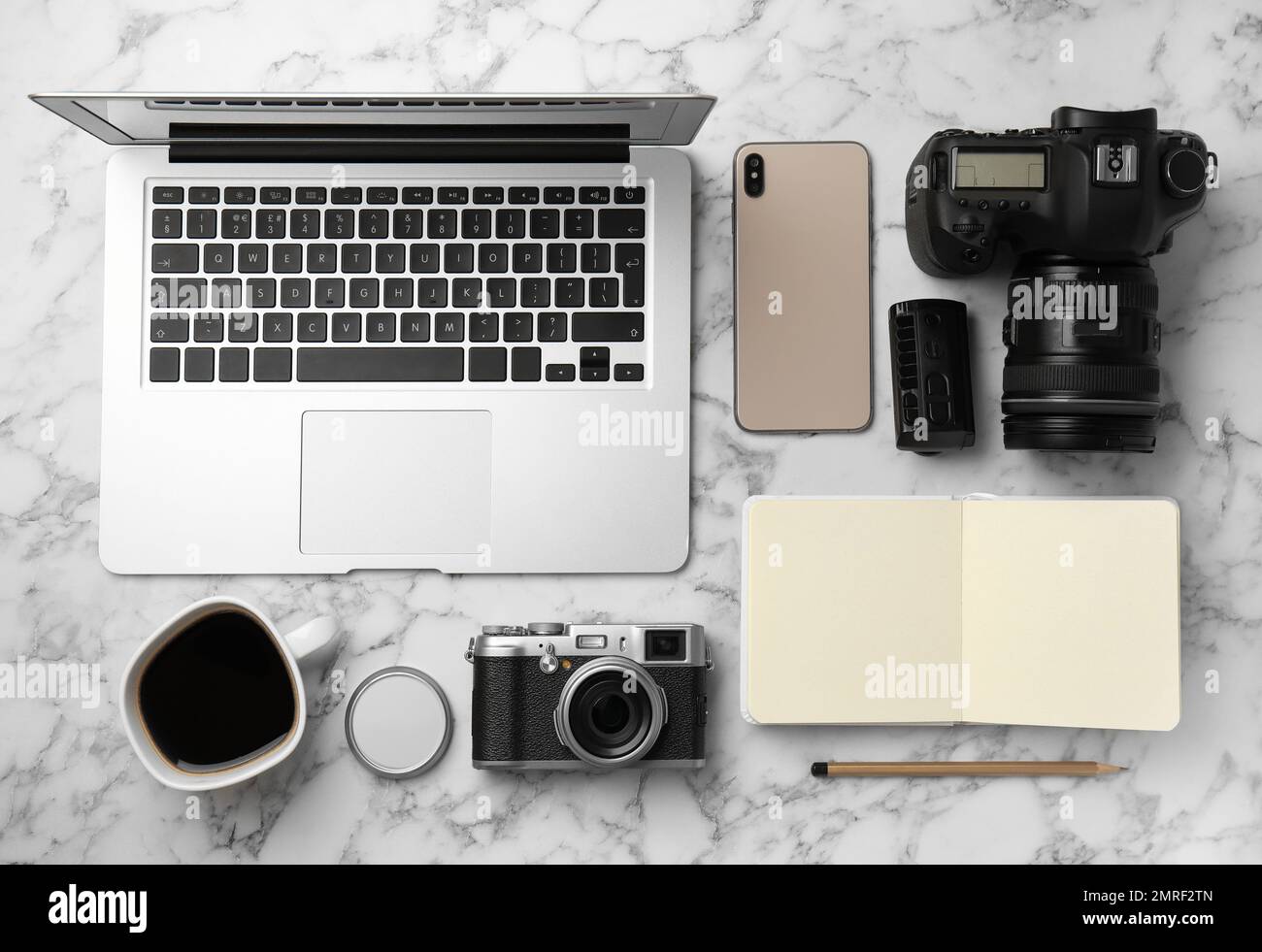 Flat lay composition with laptop, cameras and smartphone on white ...