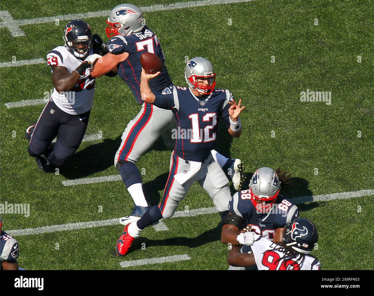 New England Patriots quarterback Tom Brady (12) passes under pressure ...