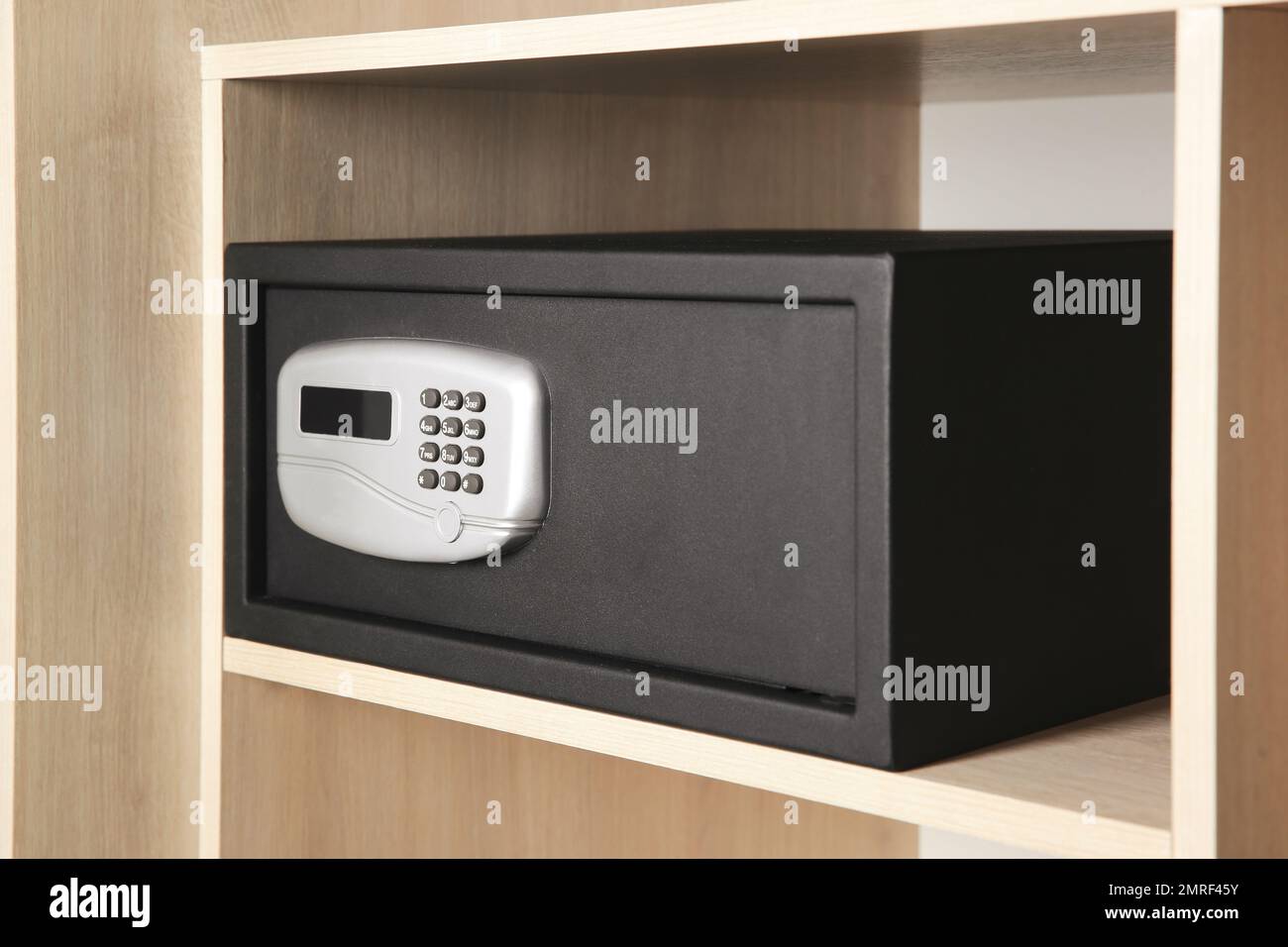 Black steel safe with electronic lock in wooden closet Stock Photo - Alamy