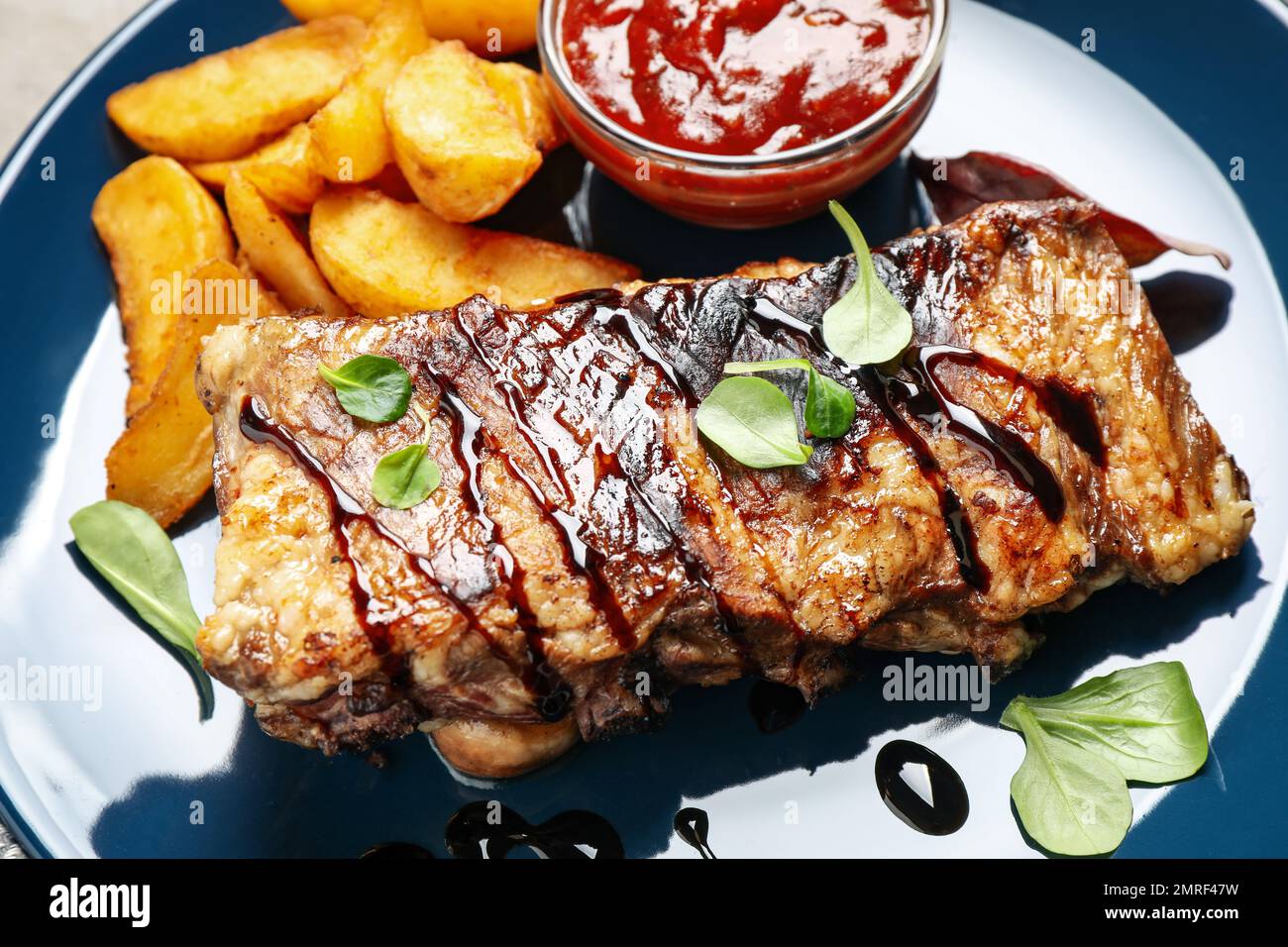 Delicious grilled ribs in plate, closeup view Stock Photo - Alamy