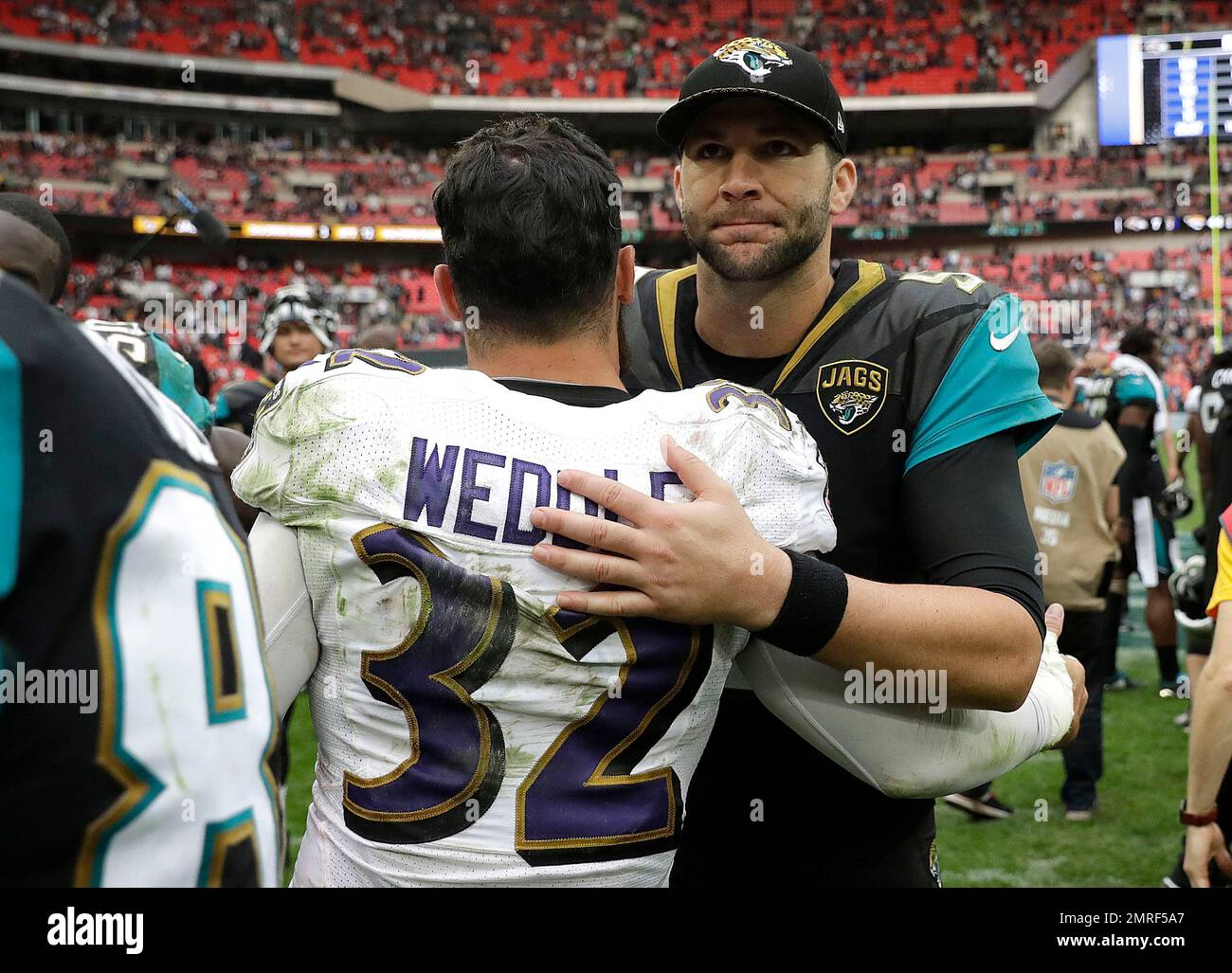 Jacksonville Jaguars quarterback Blake Bortles, right, greets Baltimore ...