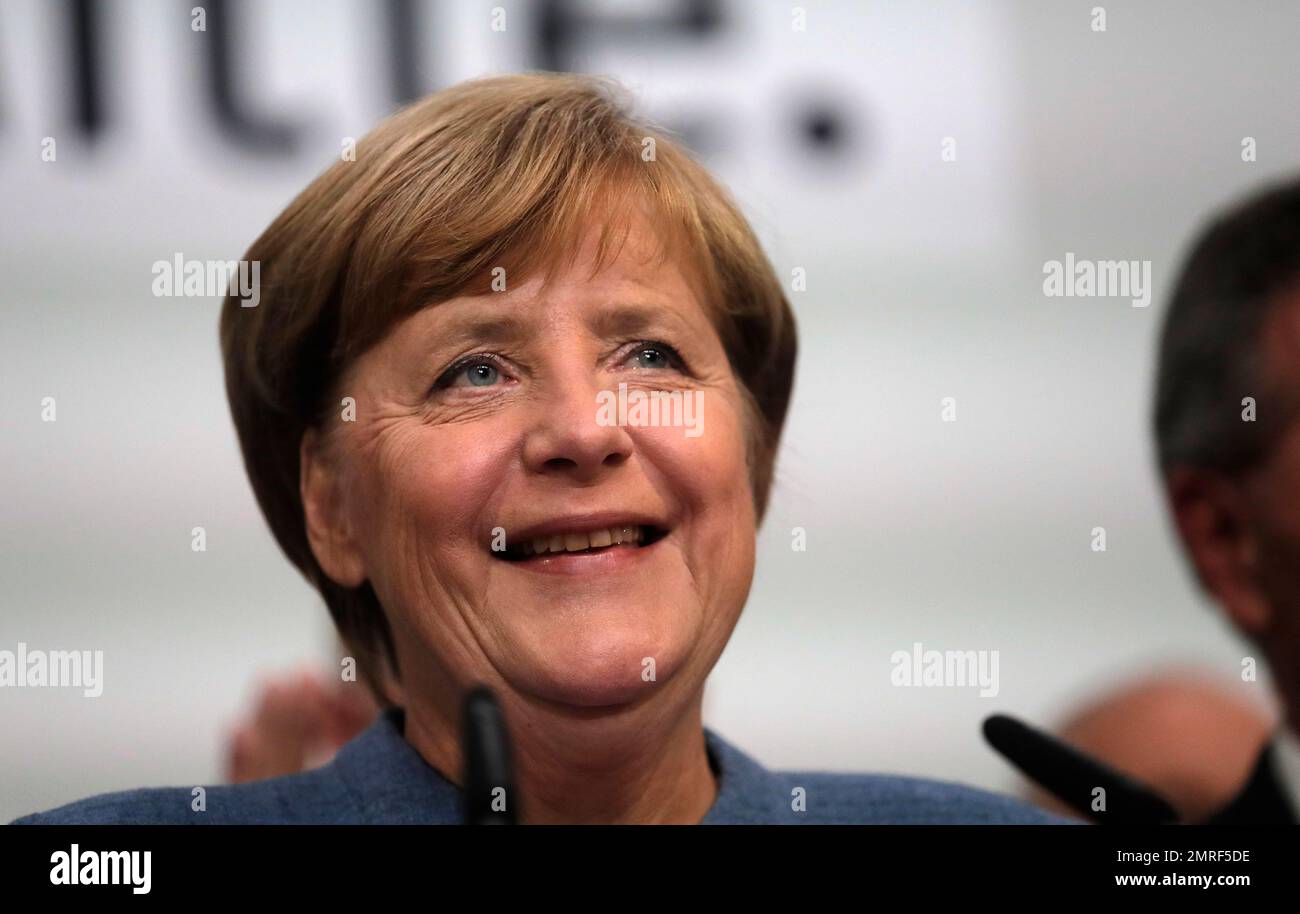German Chancellor Angela Merkel smiles as she delivers a speech after ...