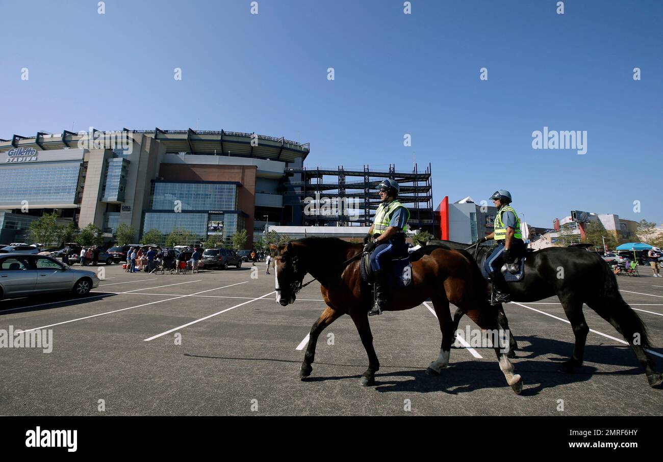 Mounted police officers ride horses in the parking lot of Gillette ...