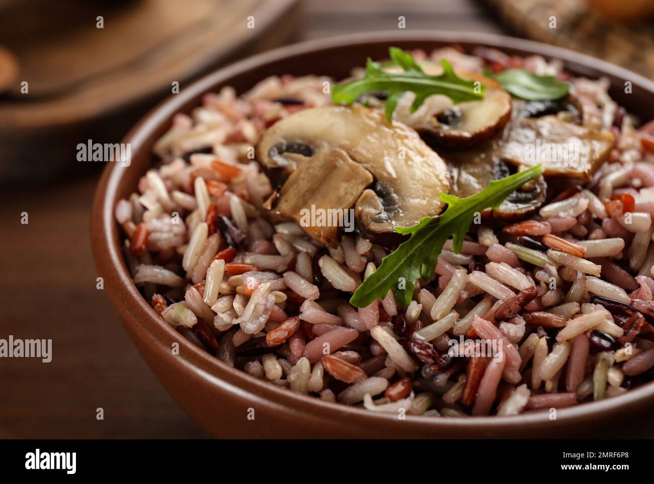 Delicious brown rice in bowl, closeup view Stock Photo - Alamy