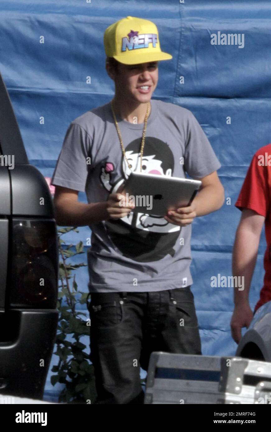 Teen pop superstar Justin Bieber carries an iPad as he arrives on the ...