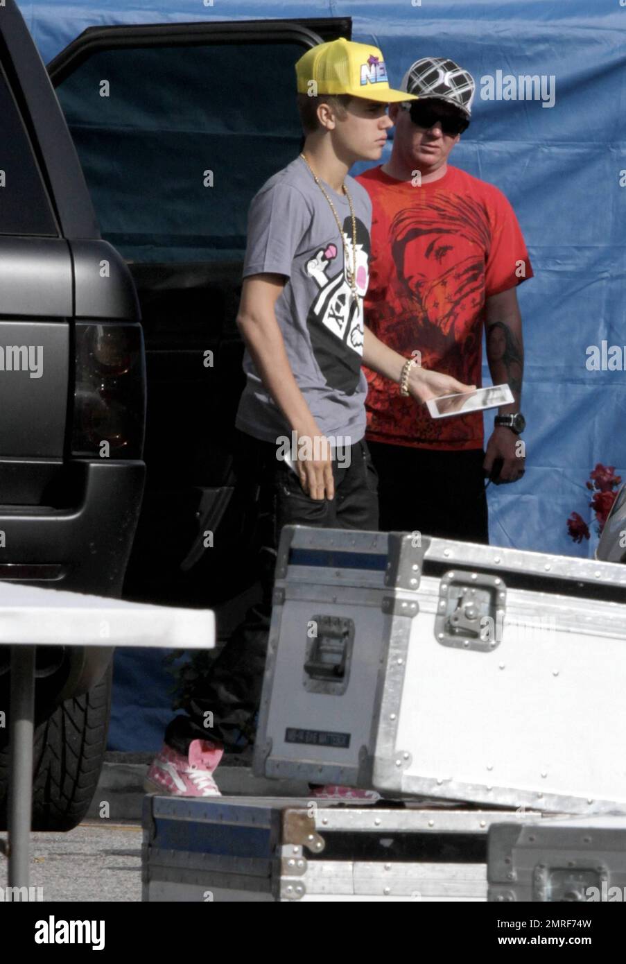 Teen pop superstar Justin Bieber carries an iPad as he arrives on the ...
