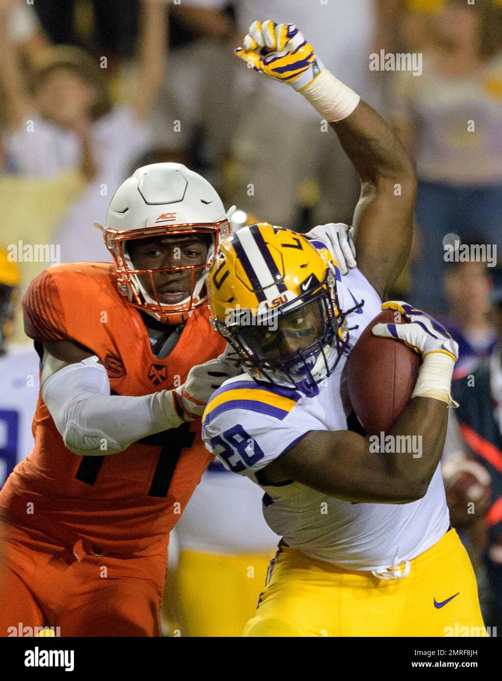 Syracuse defensive back Evan Foster (14) tangles with LSU running back ...