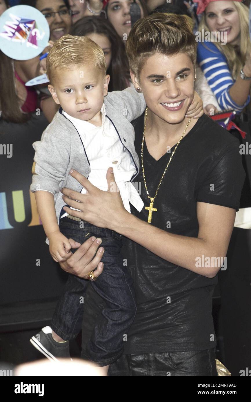 Justin Bieber carries baby brother Jaxon at the 23rd Annual MuchMusic ...