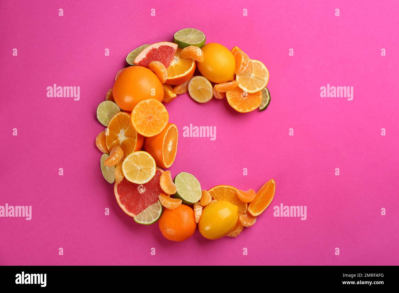 Letter C made with citrus fruits on pink background as vitamin ...