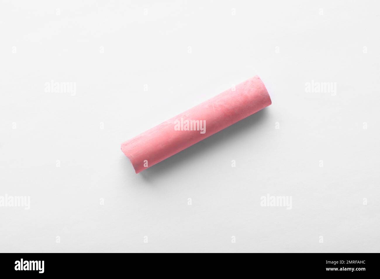 Small piece of pink chalk isolated on white, top view Stock Photo - Alamy
