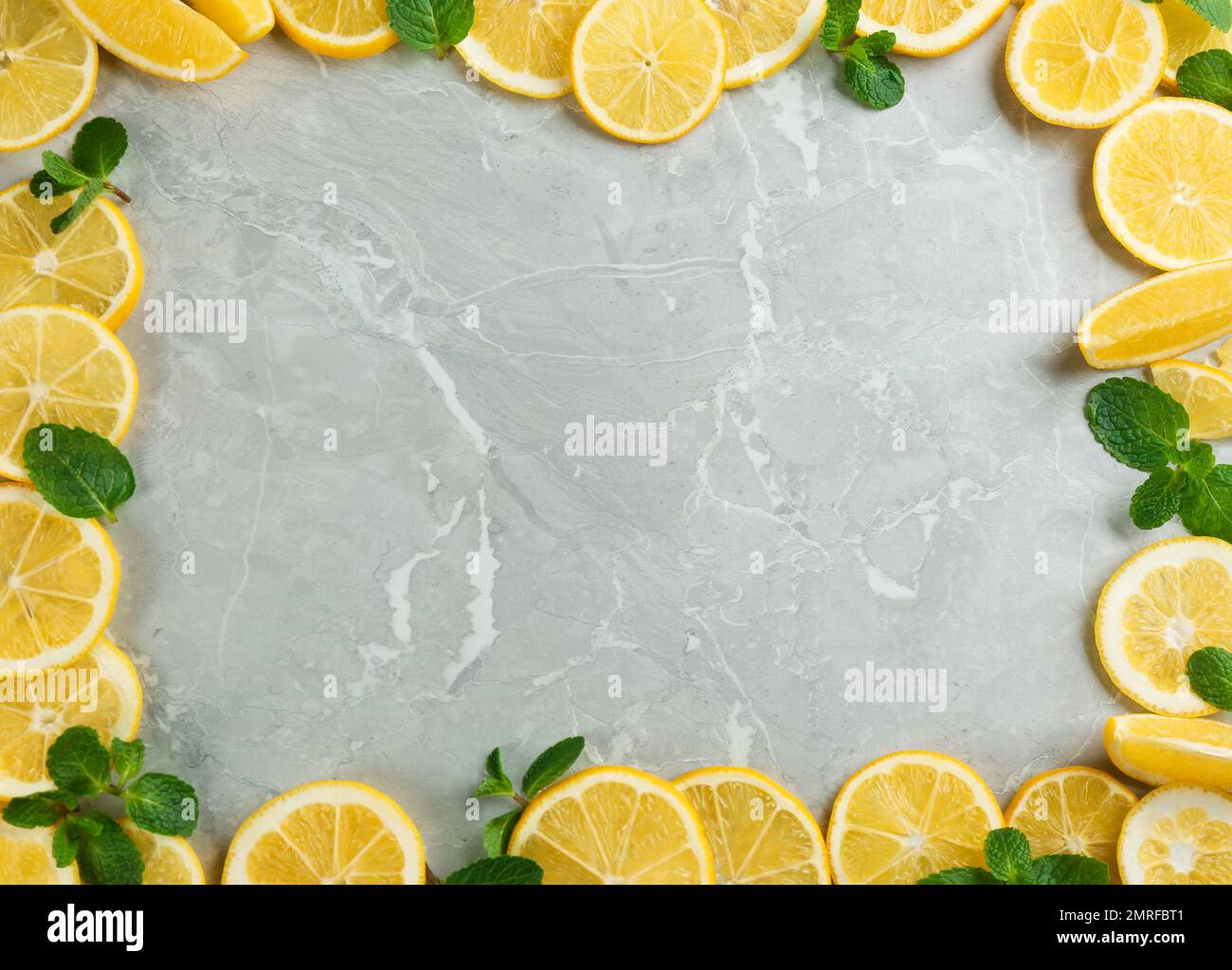 Frame made with ingredients for lemonade on grey marble background, top ...