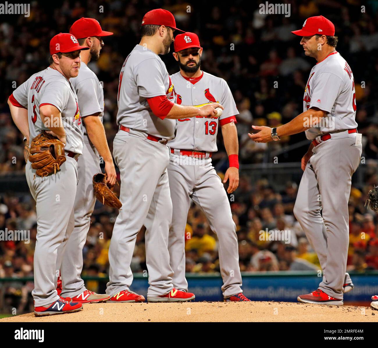 St. Louis Cardinals manager Mike Matheny, right, takes the ball from ...