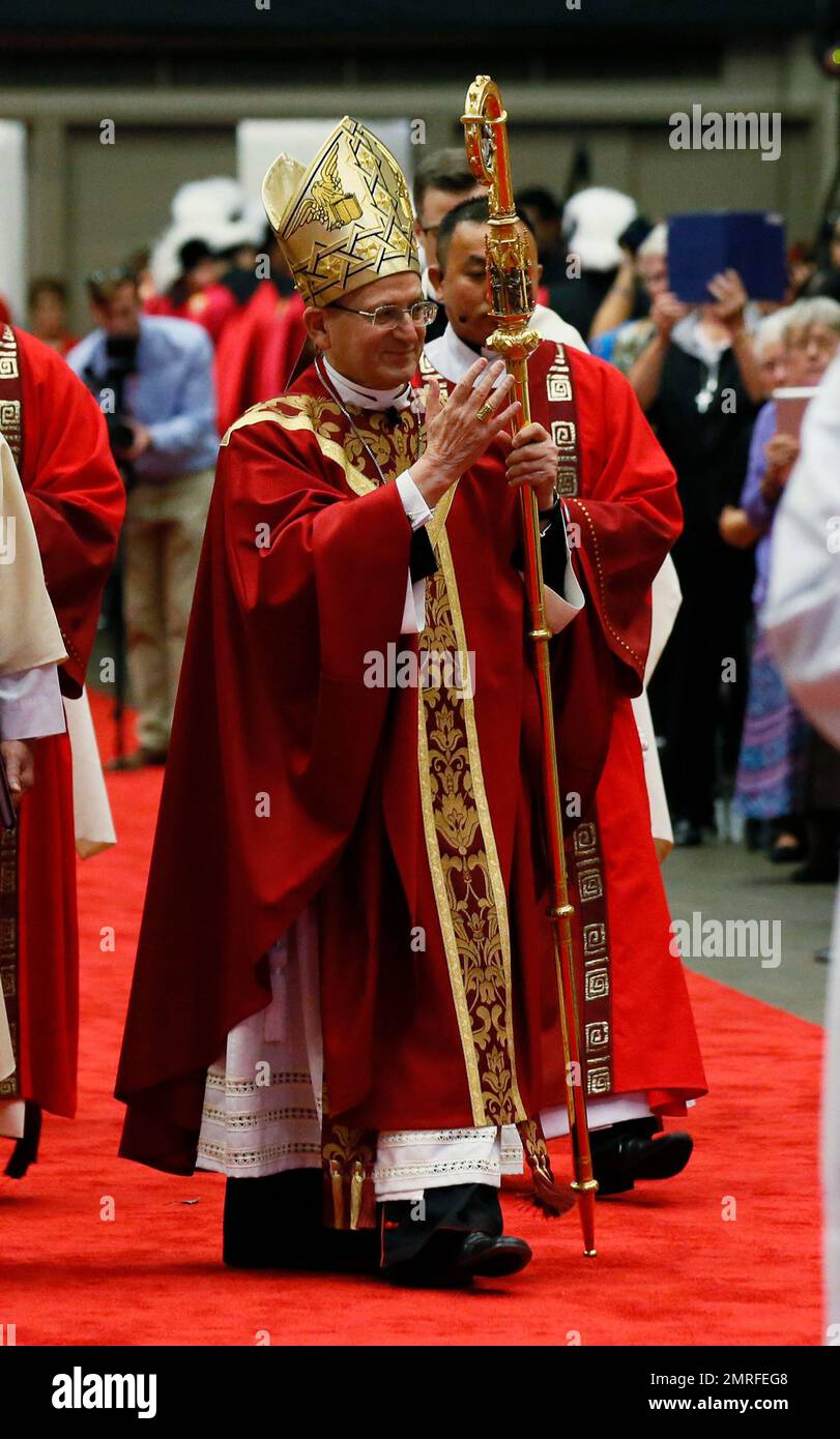 Cardinal Angelo Amato gives blessing as he walks in a procession during ...