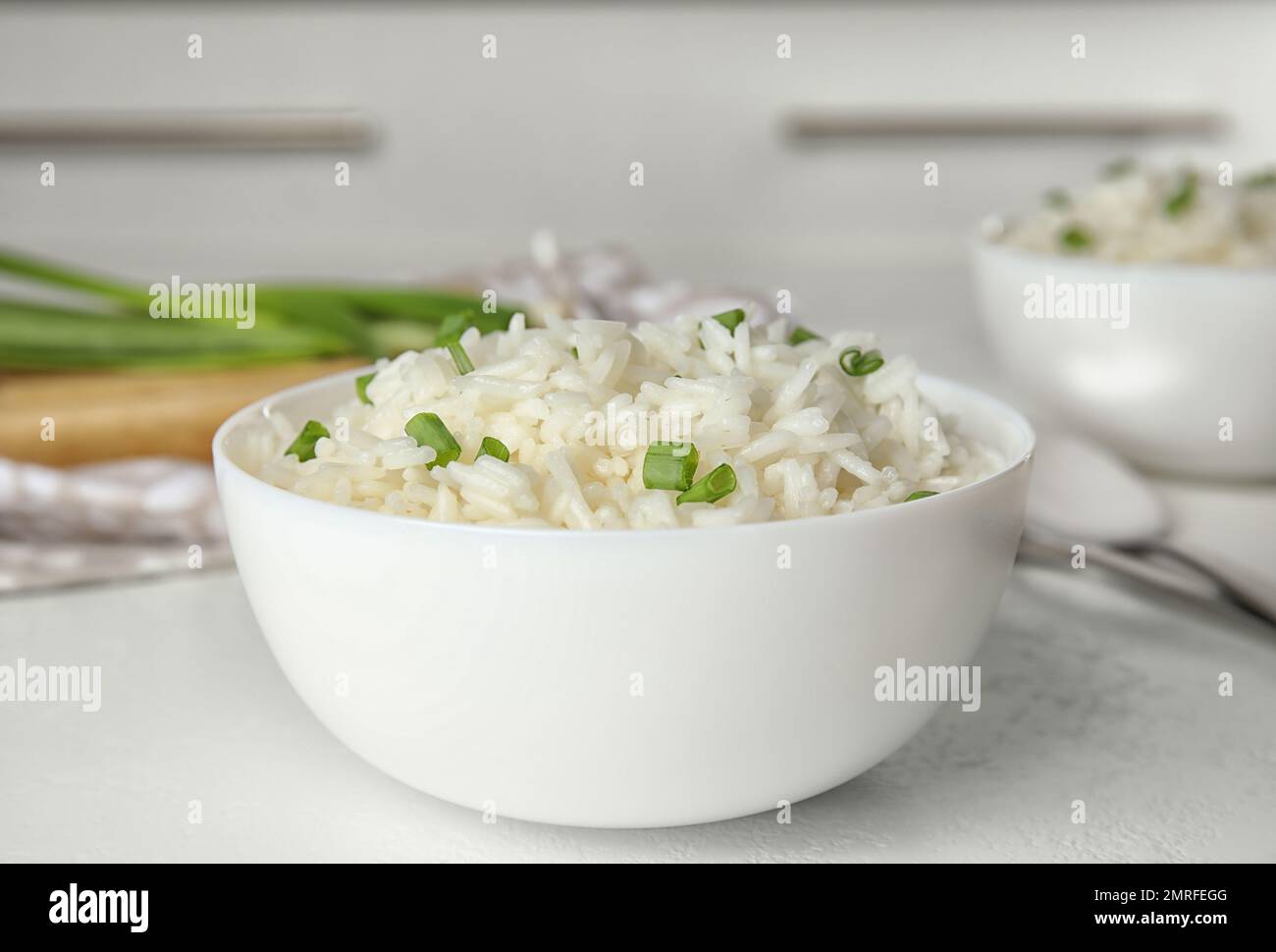 Bowl with tasty cooked rice on white table Stock Photo - Alamy