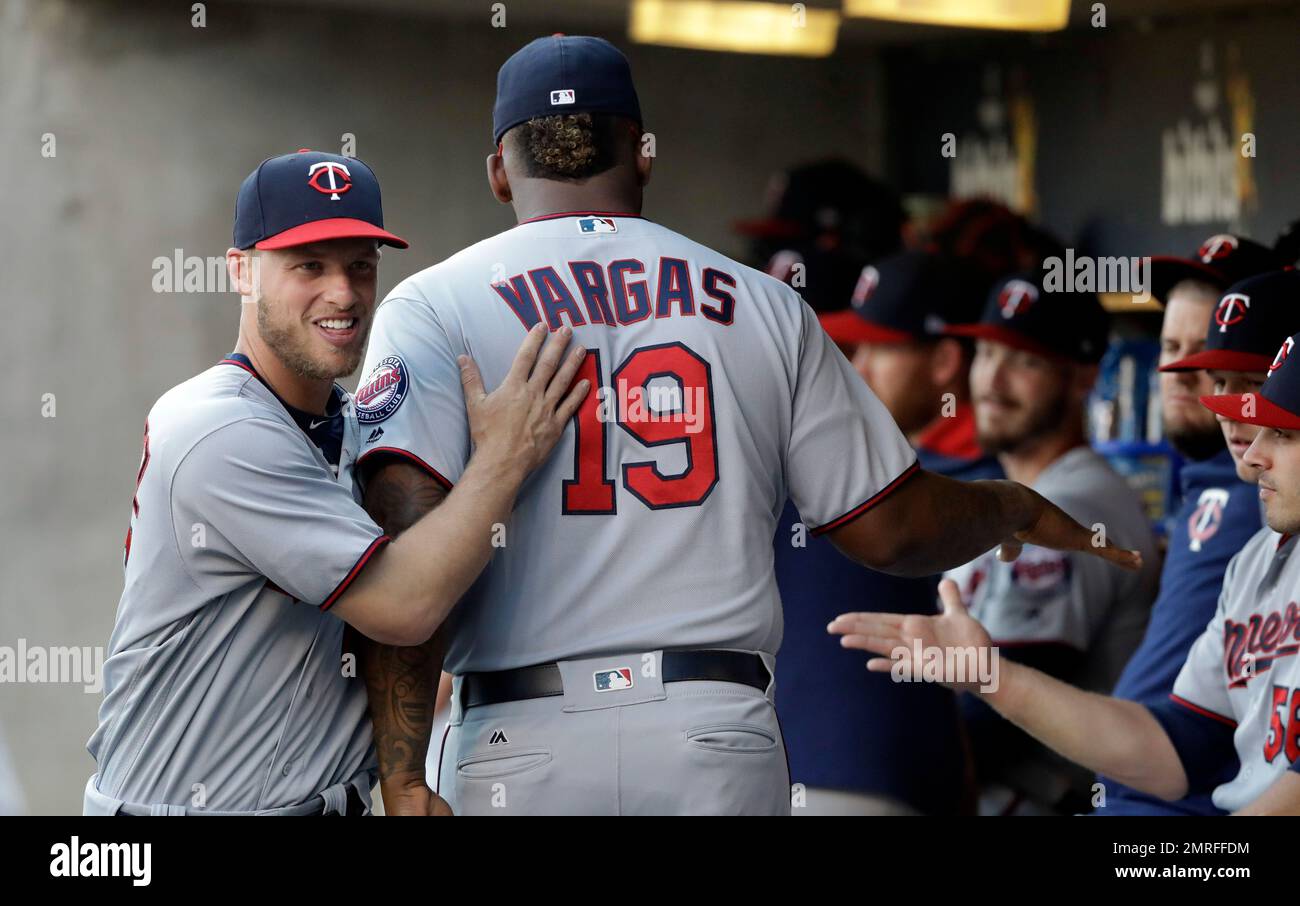 Minnesota Twins relief pitcher Alan Busenitz, left, pats first baseman ...