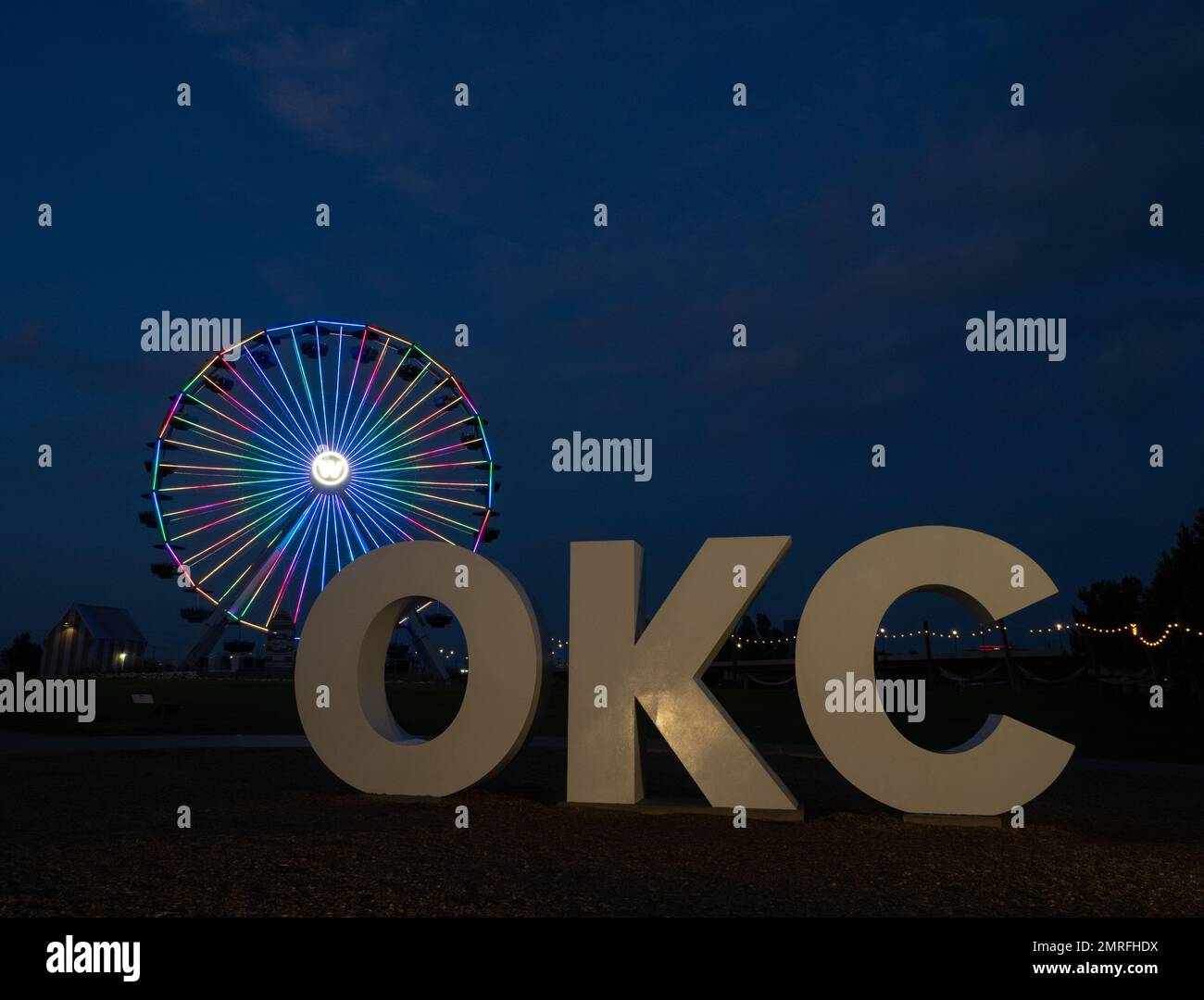 Iconic large aluminum OKC sign with Wheeler Park with the Wheeler ...