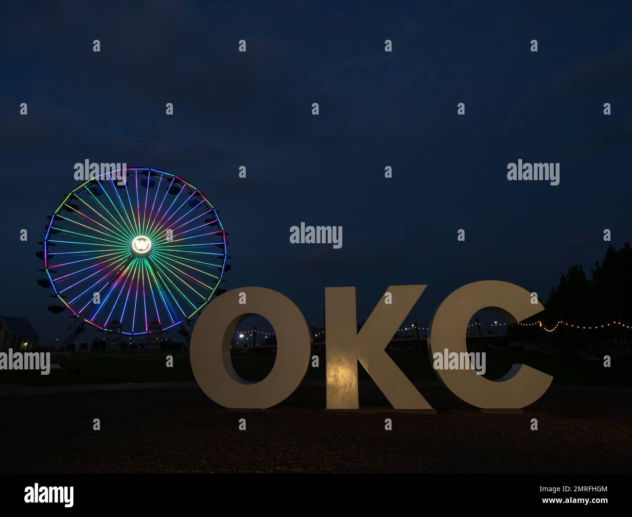 OKC sign photographed at the blue hour with the lit, stationary Wheeler ...