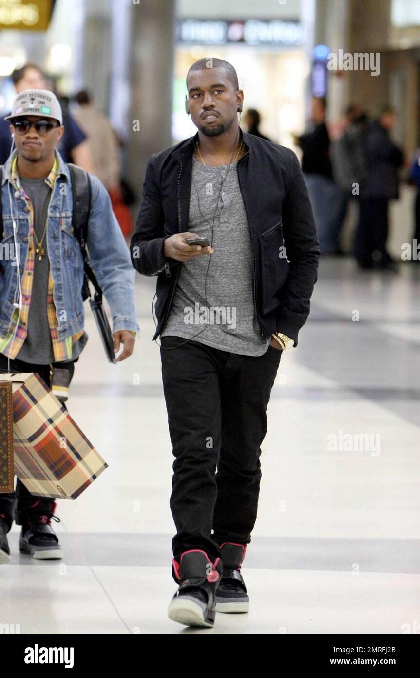 Exclusive!! Kanye West and his posse stroll towards baggage claim at ...