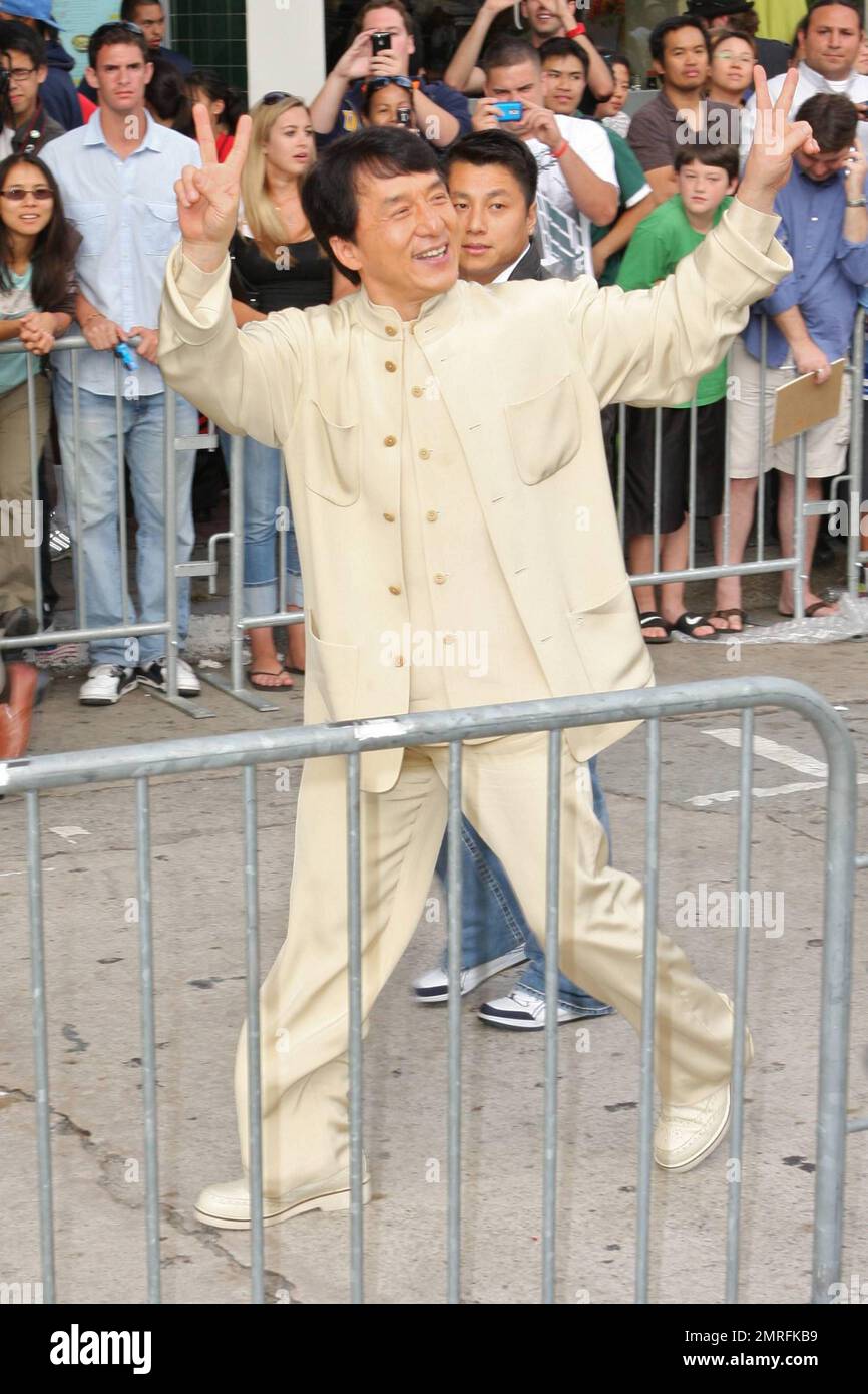 Jackie Chan walks the red carpet and poses on a prop at the premiere of ...