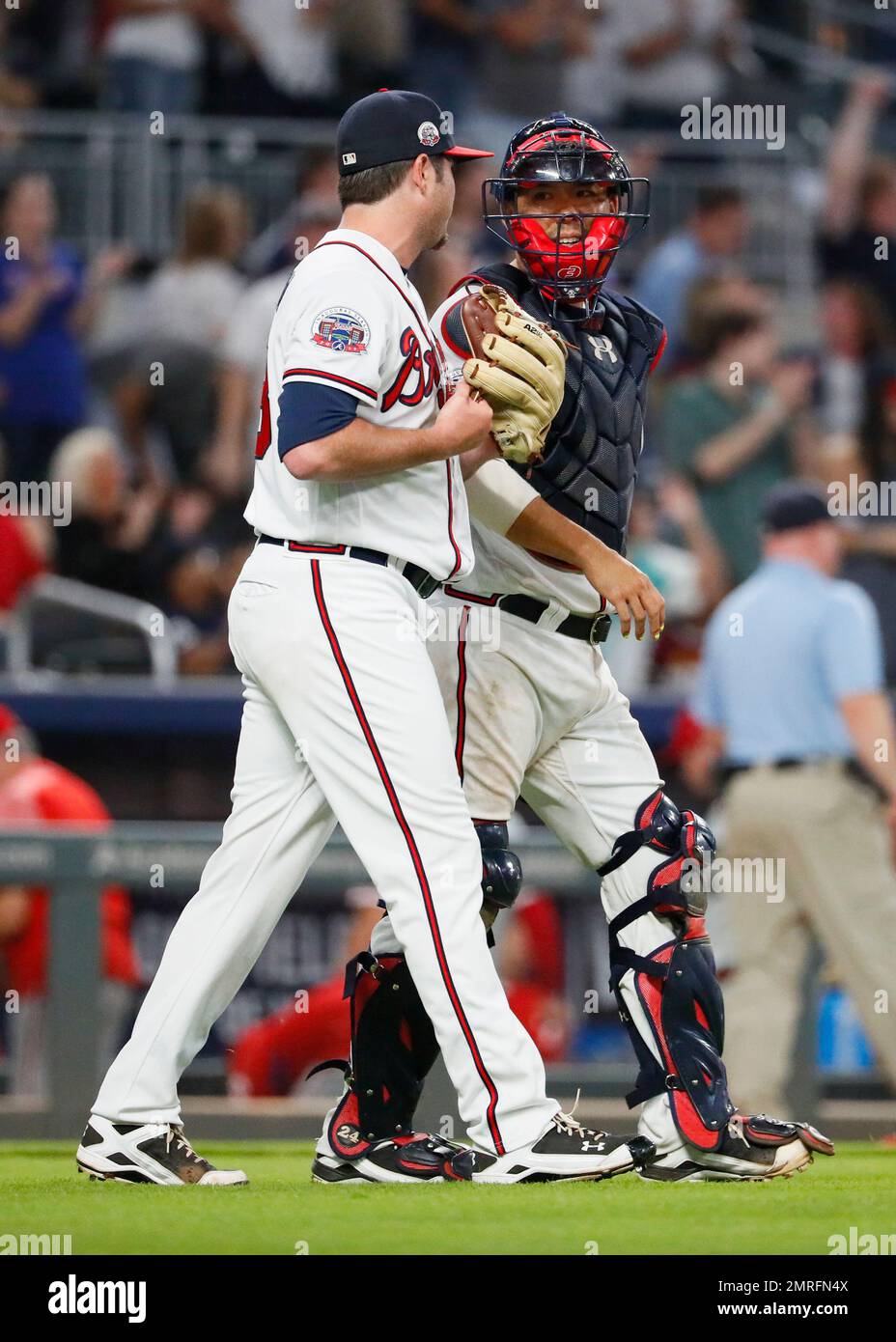 Atlanta Braves catcher Kurt Suzuki reacts with relief pitcher Luke ...