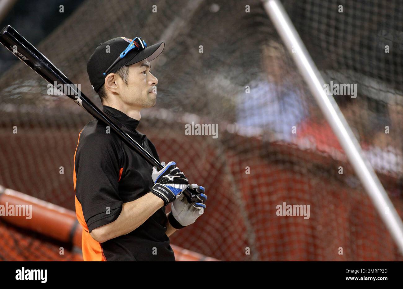Miami Marlins' Ichiro Suzuki looks on as he waits to take batting ...