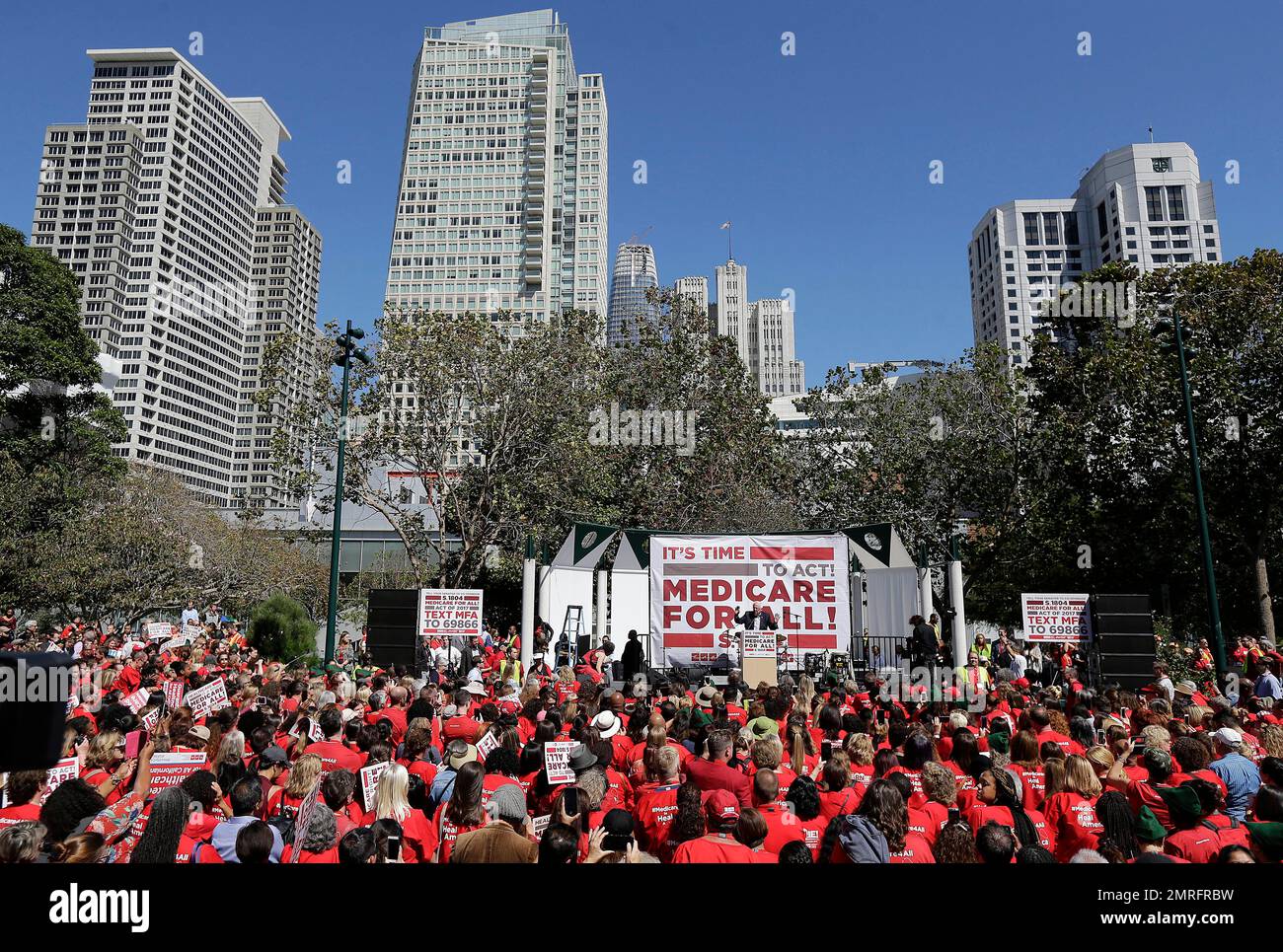 Sen. Bernie Sanders, I-Vt., center background, speaks at a health care ...