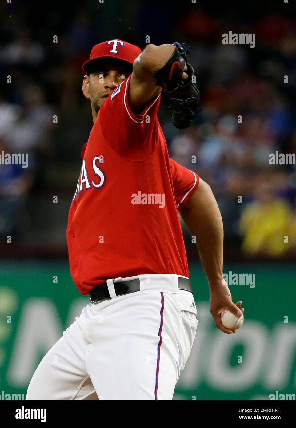 Texas Rangers starting pitcher Tyson Ross winds up to throw to the ...