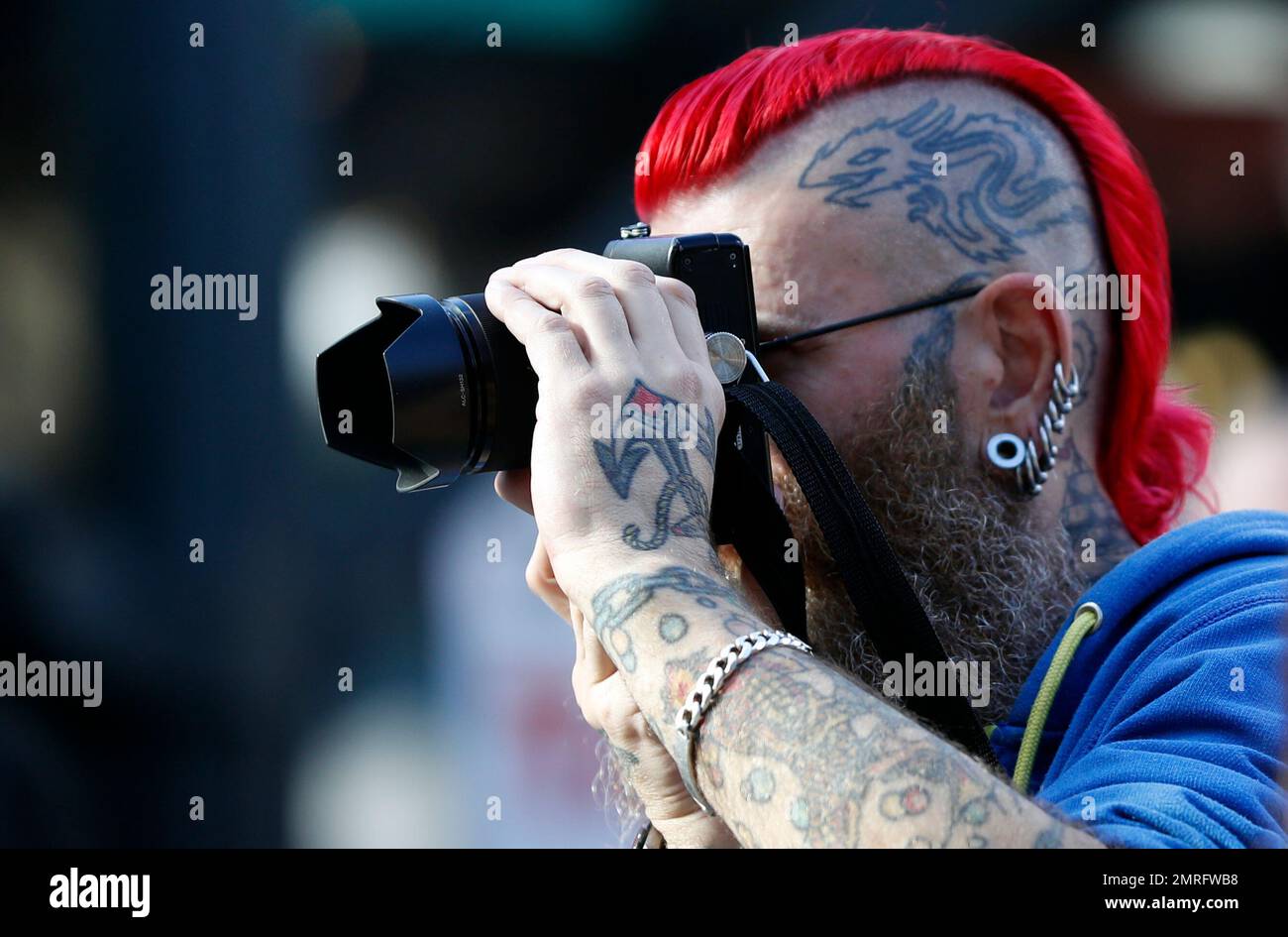 A visitor takes a photograph at The International Tattoo Convention in ...