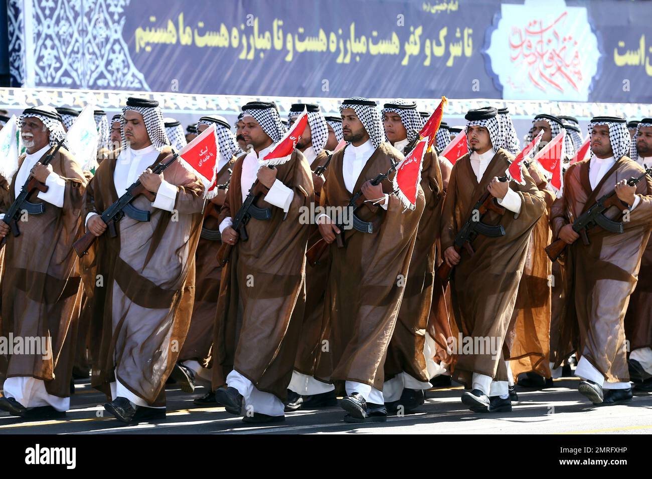 Iranian Arabs who are members of the paramilitary Basij force march in ...