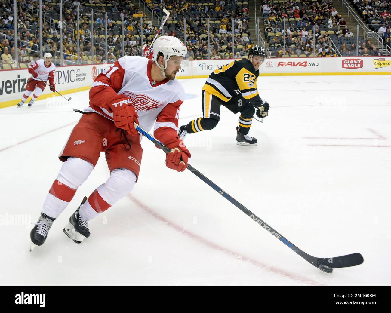 Detroit Red Wings' Xavier Ouellet skates with the puck during the first ...
