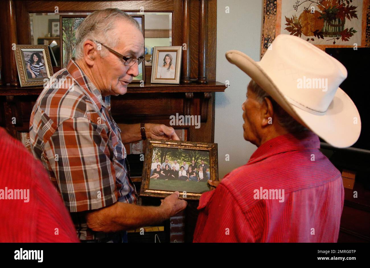 Thomas Rother, left, shows family photos to Antonio Pop Mesia, right ...