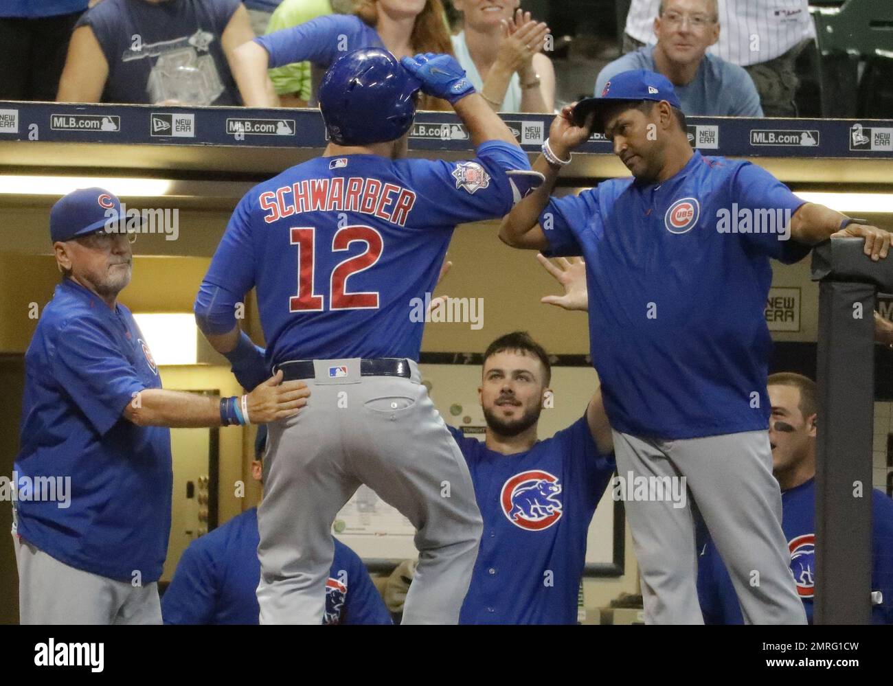 Chicago Cubs' Kyle Schwarber is congratulated after hitting a home run ...