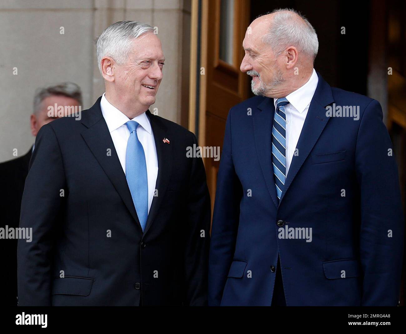 Defense Secretary Jim Mattis, left, smiles as he greets Polish Defense ...