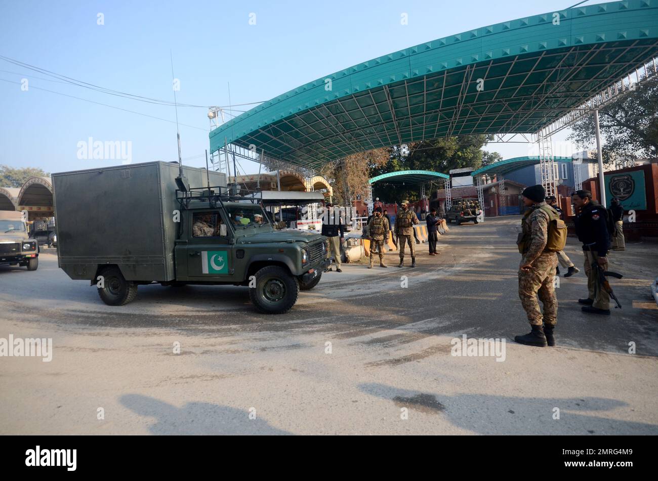 Pakistani security officials conduct a checkpoint near the crime scene ...