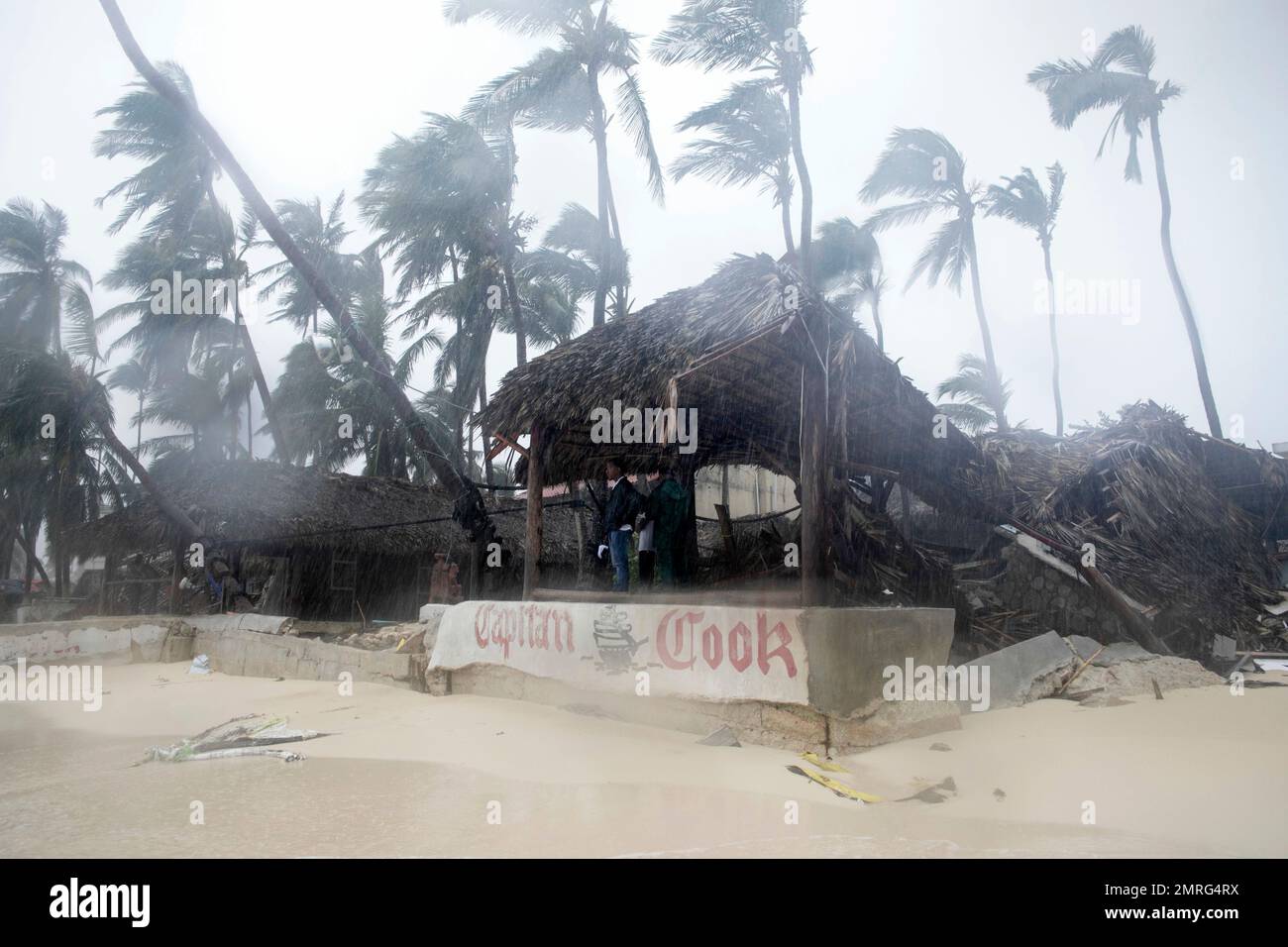 A person looks out from the Captain Cook restaurant damaged during the ...