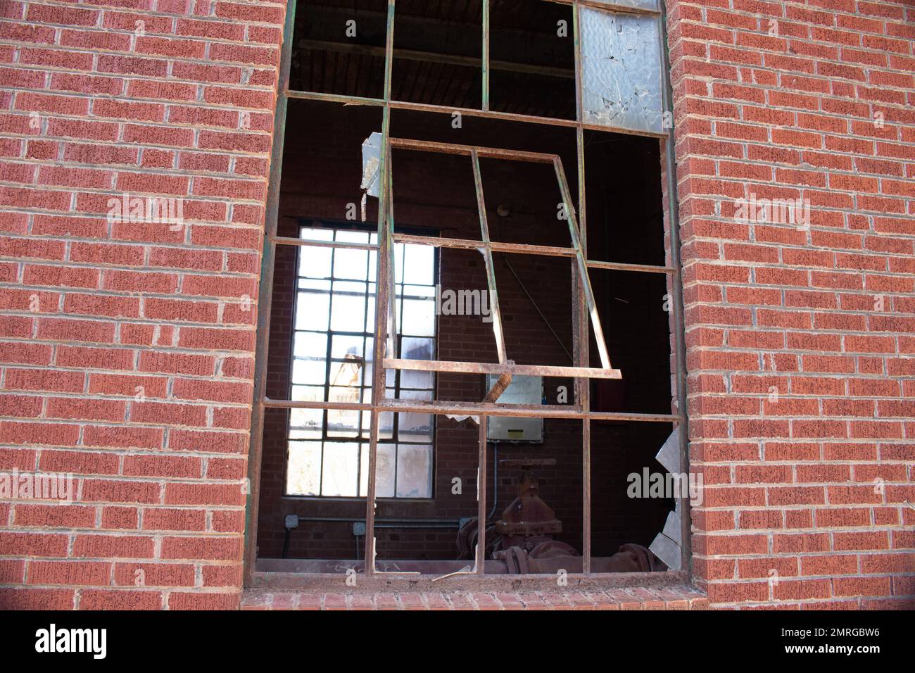 Broken window frame on an abandoned red brick building Stock Photo - Alamy