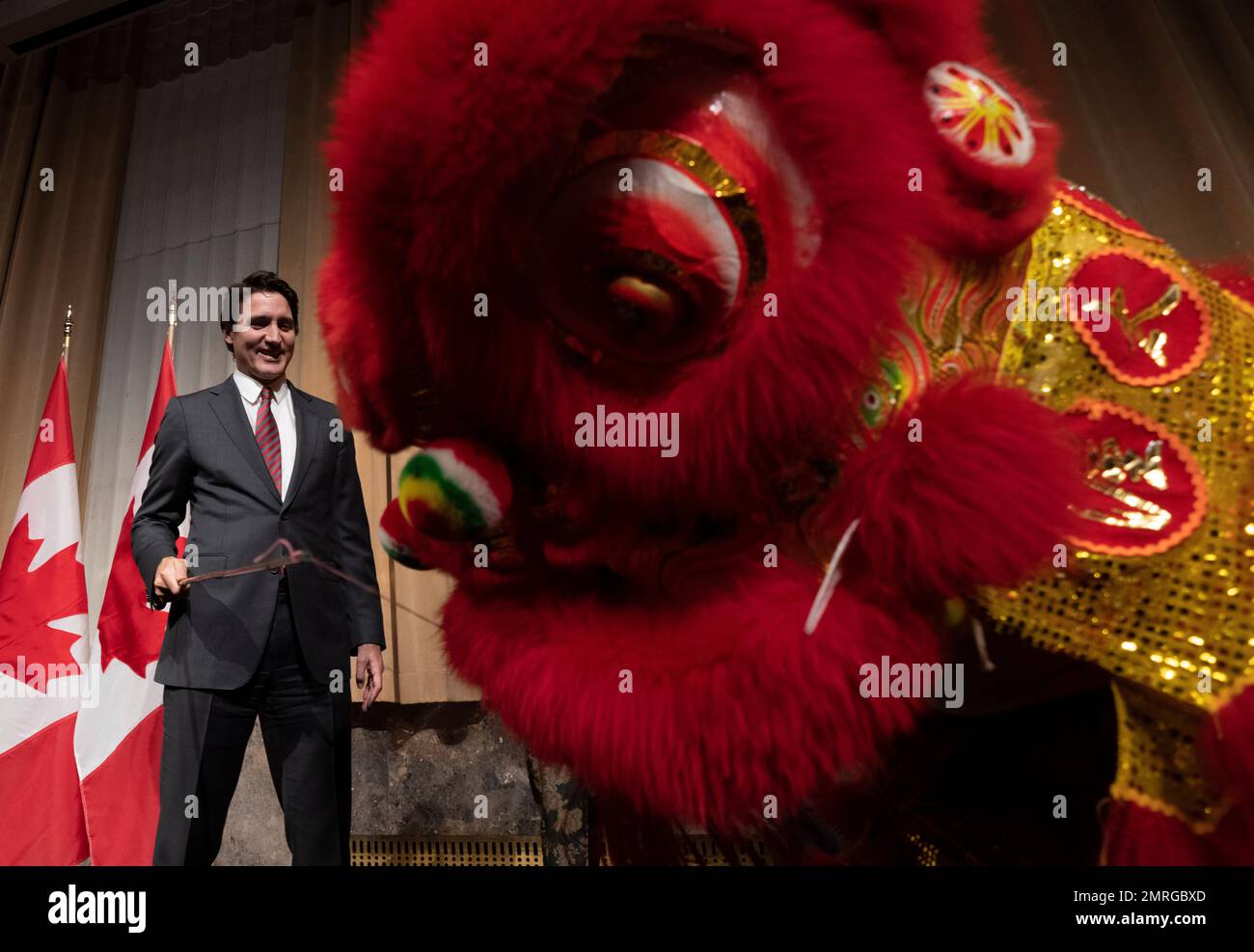 Prime Minister Justin Trudeau holds on to a pole during a lion dance at ...