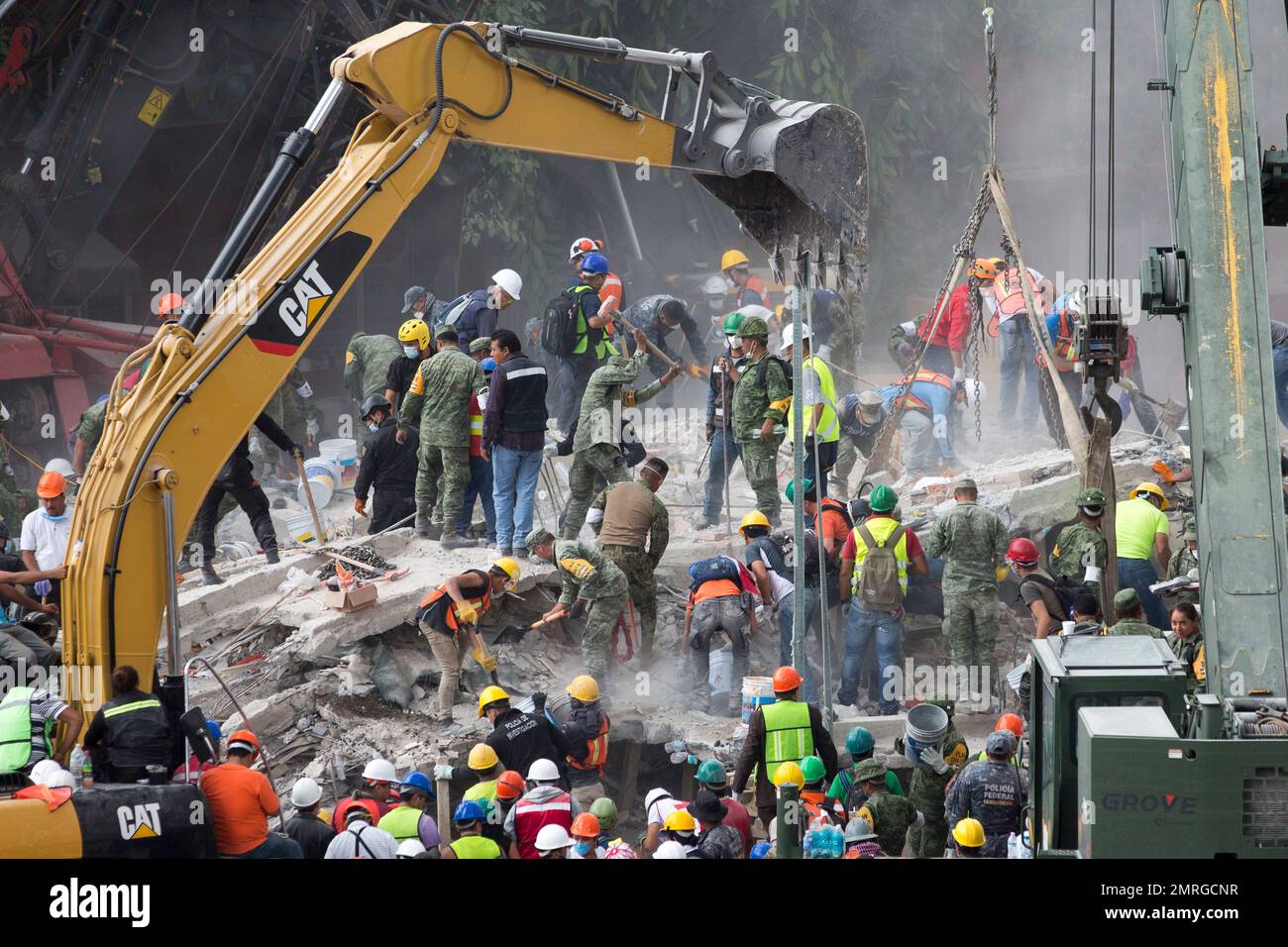 Rescue personnel work on a collapsed building, a day after a ...