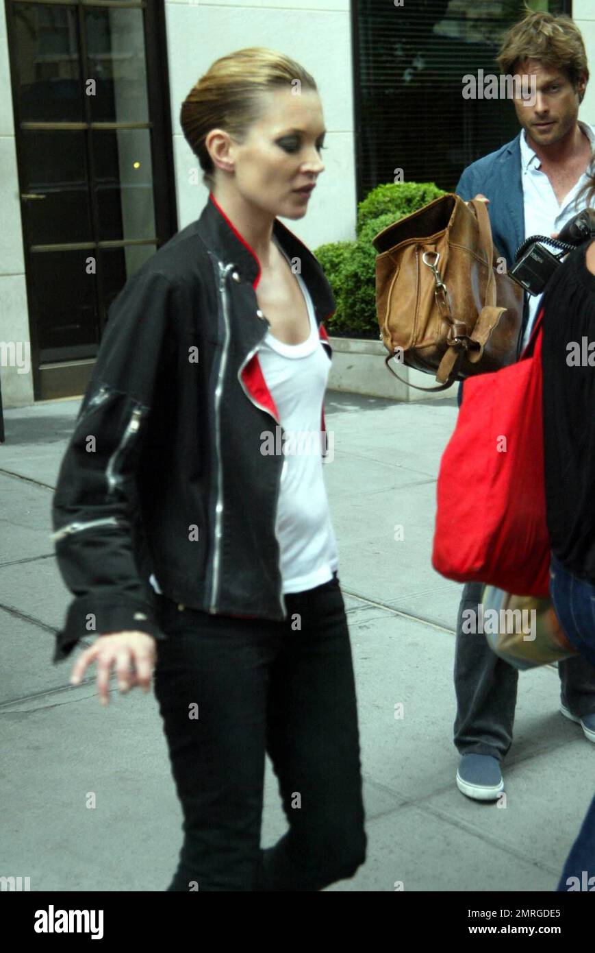 The seemingly bra-less Kate Moss wears a very revealing t-shirt as she ...