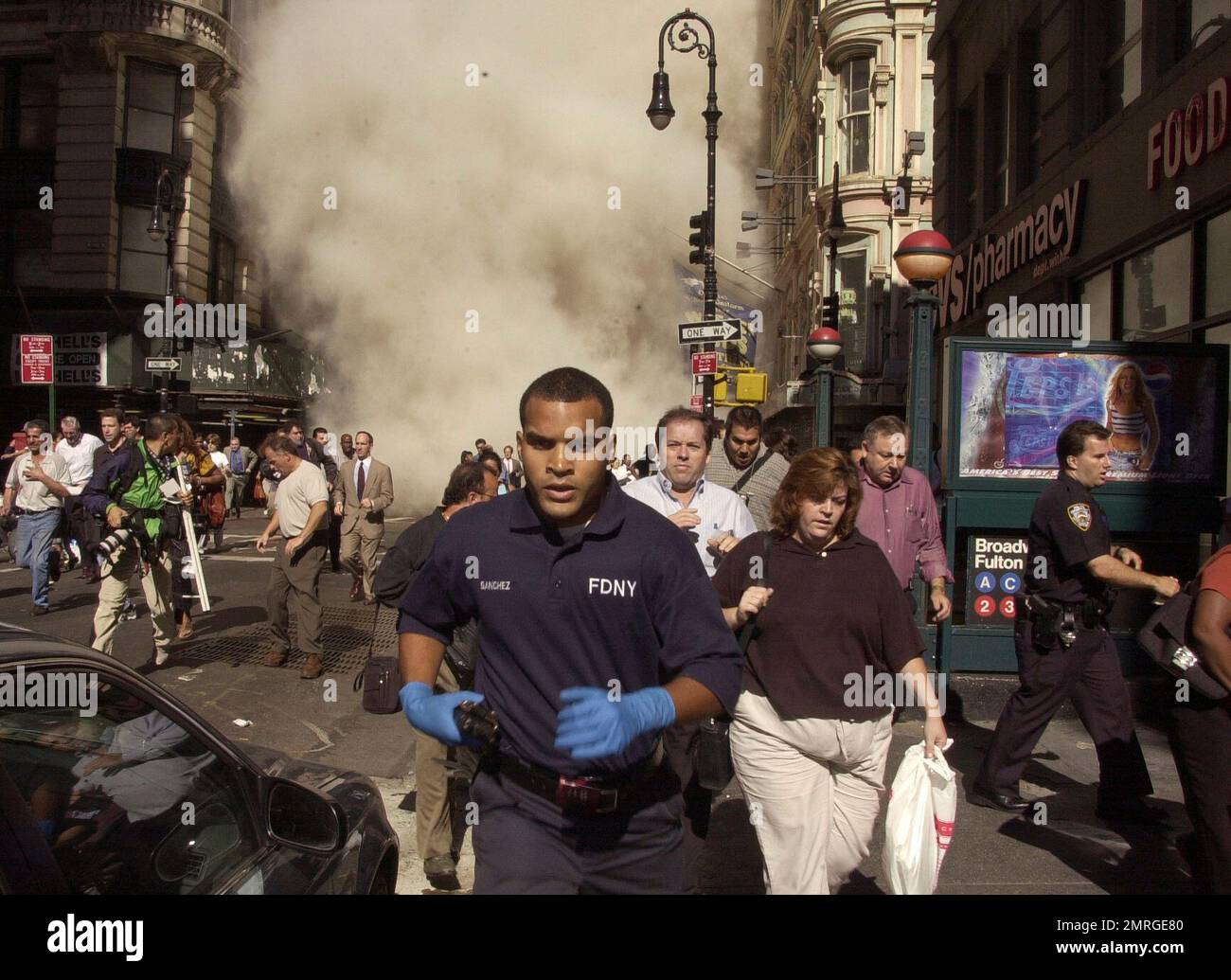 People run from the collapse of the north tower of the World Trade ...