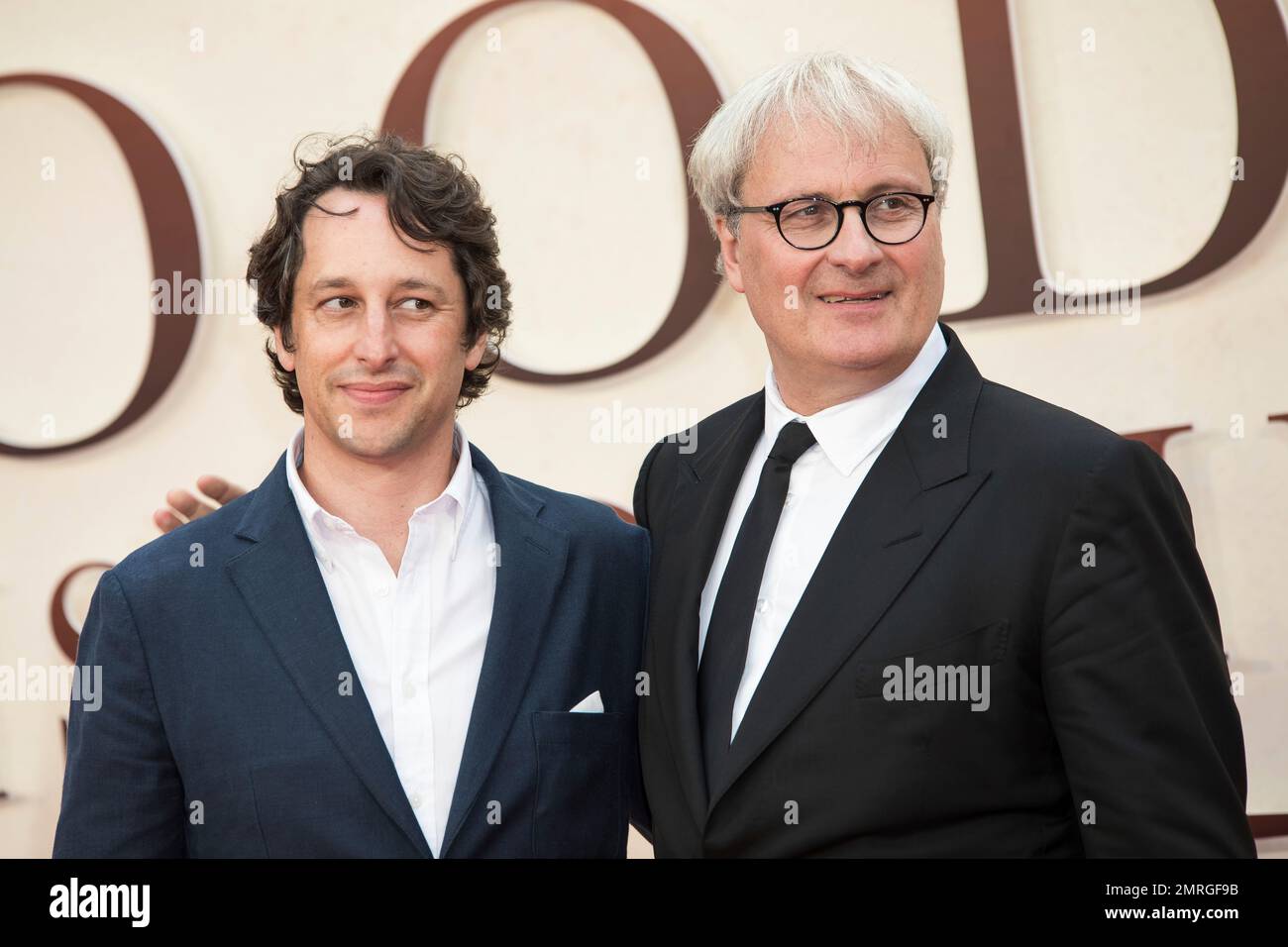Director Simon Curtis, right, poses for photographers upon arrival at ...