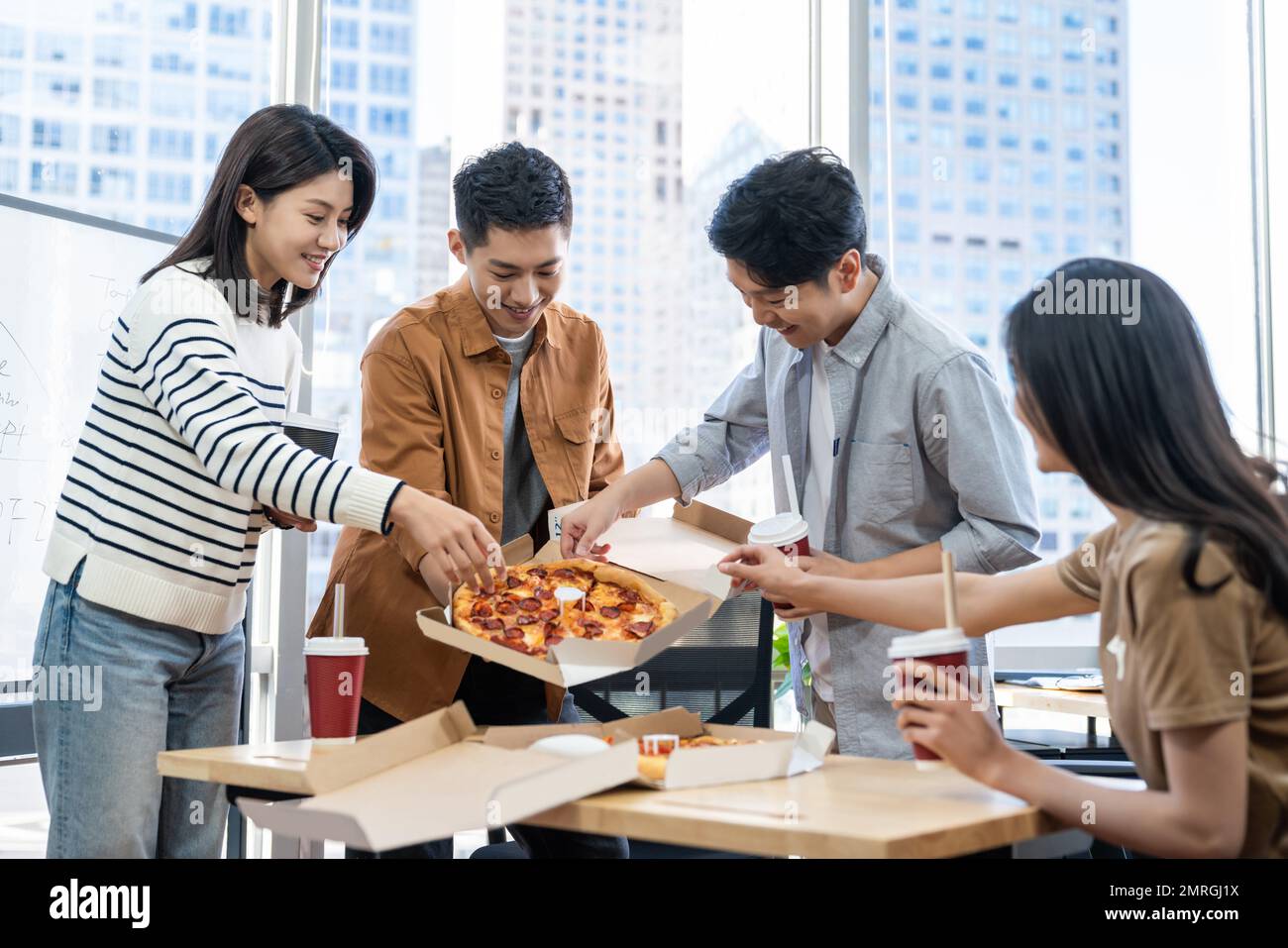Young business people in the office to work overtime to eat fast food ...