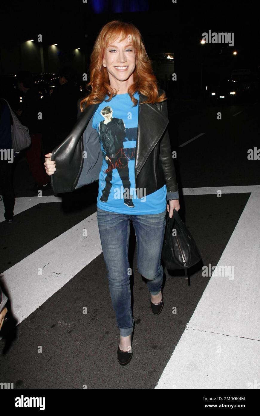 Flashing her Justin Bieber shirt and carrying a Chanel handbag Kathy ...